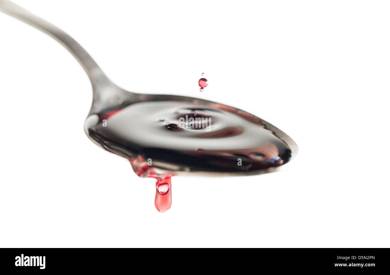 Syrup with drops on blurred spoon Stock Photo - Alamy