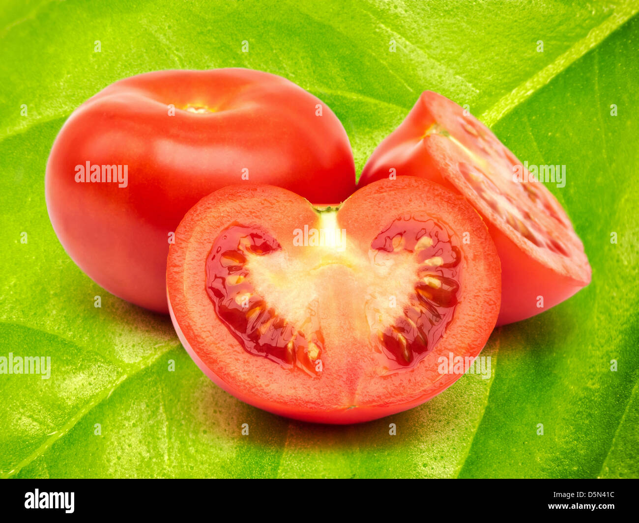 Tomatoes on Leaf Stock Photo - Alamy