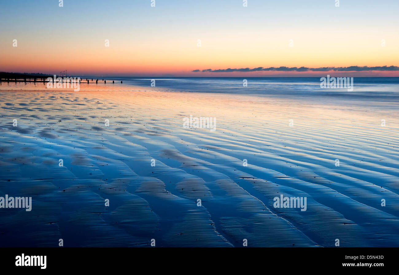 Beautiful low point of view along beach at low tide out to sea with ...
