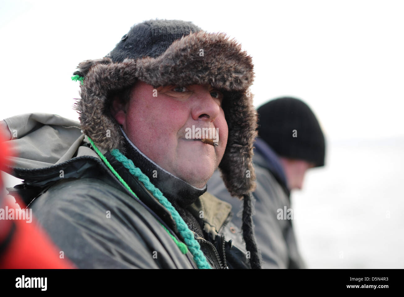 The fishman Gert Meichle pictured with a cigarillo in his mouth on his ...