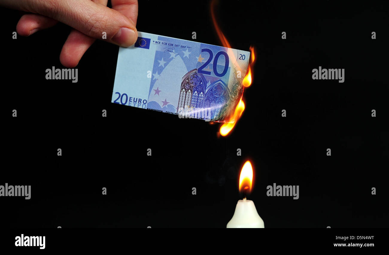 Illustration: A 20 euro note is set on fire in Dresden, Germany, 25 ...