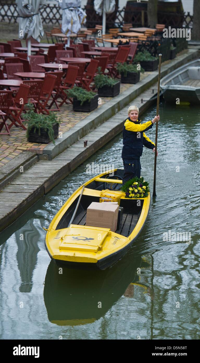 Postal worker Andrea Bunar delivers mail with a yellow post boat along ...