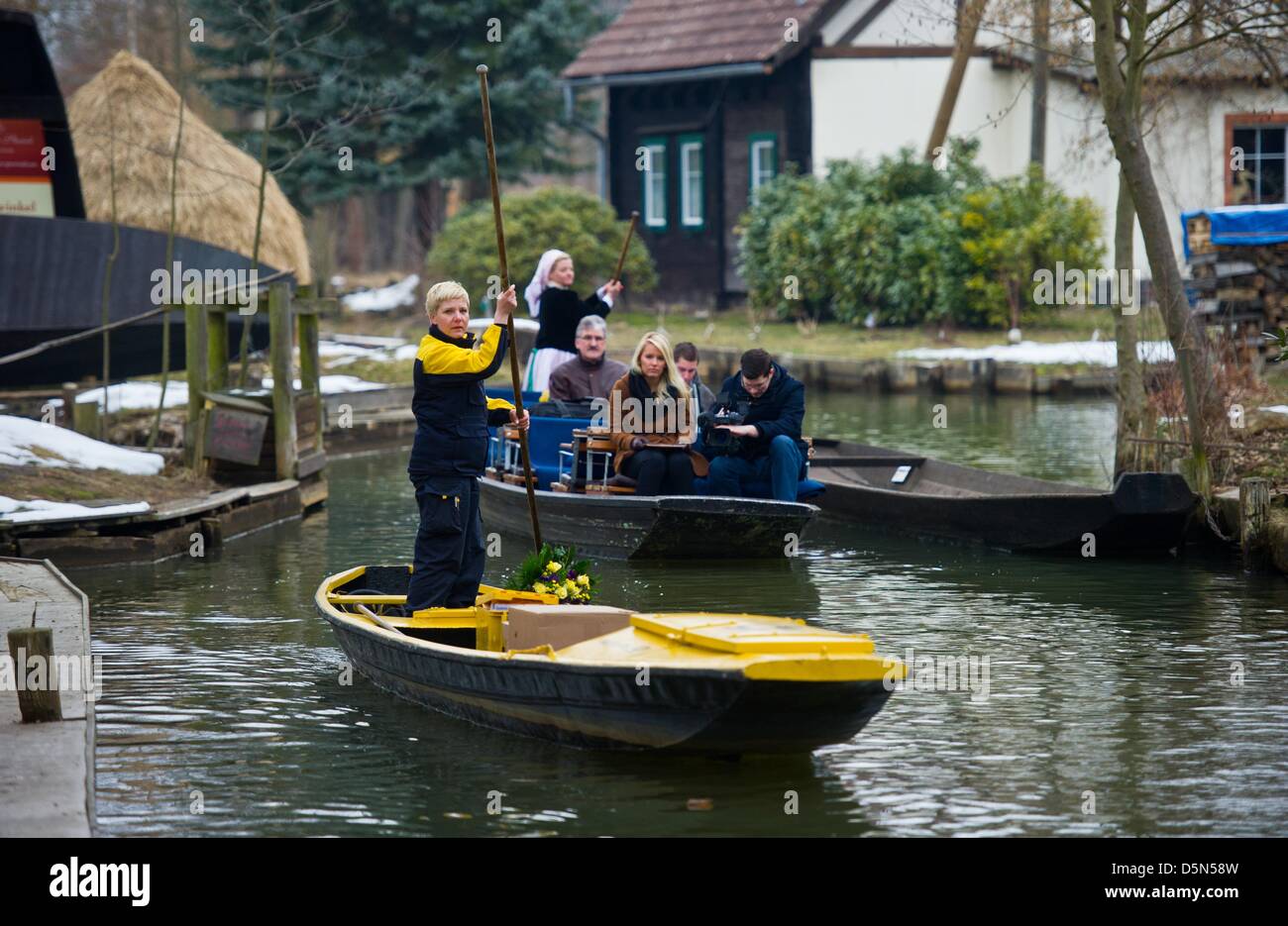 Postal worker Andrea Bunar delivers mail with a yellow post boat along ...