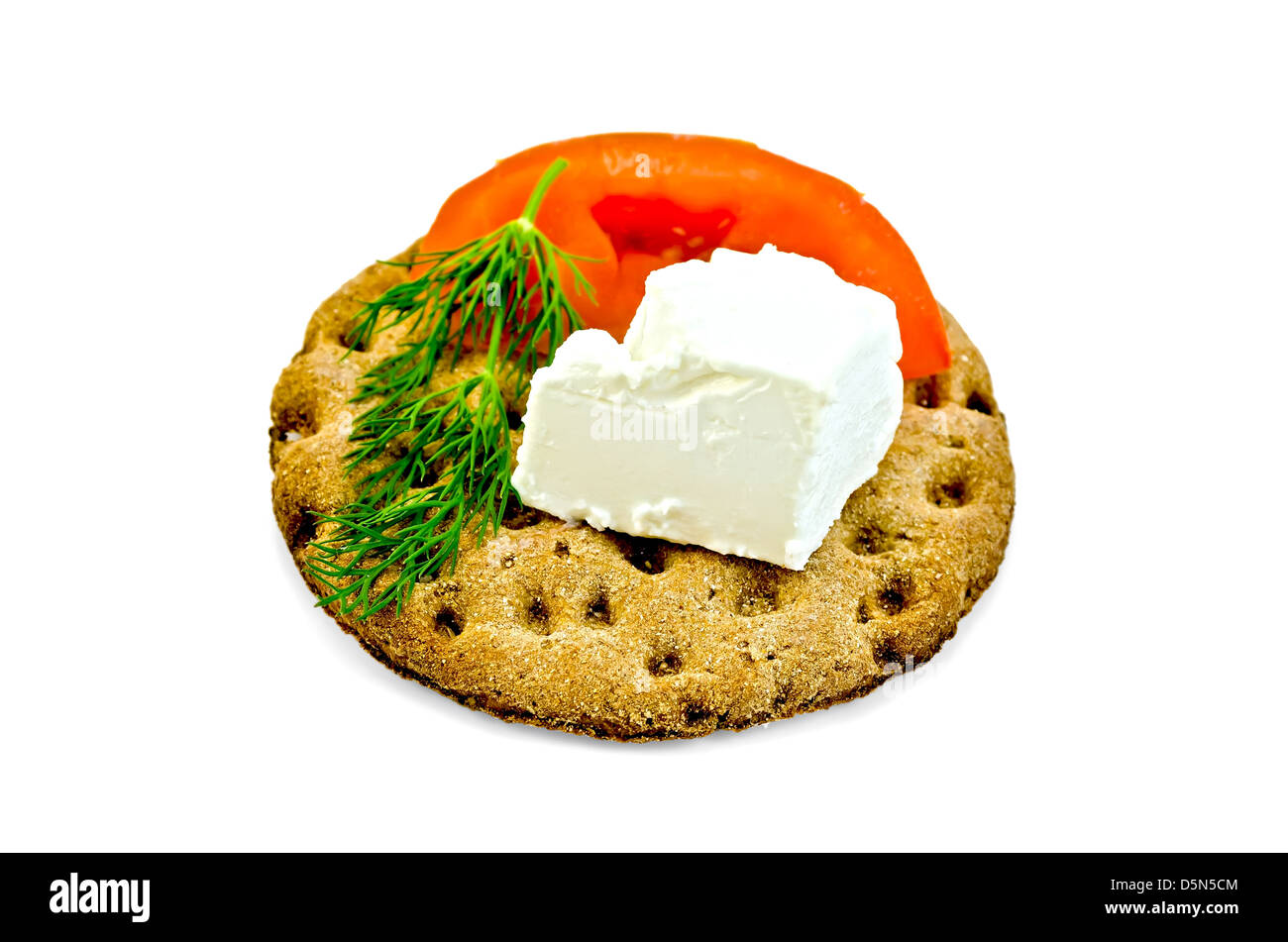 A piece of feta cheese, a slice of tomato, dill on a round rye ...
