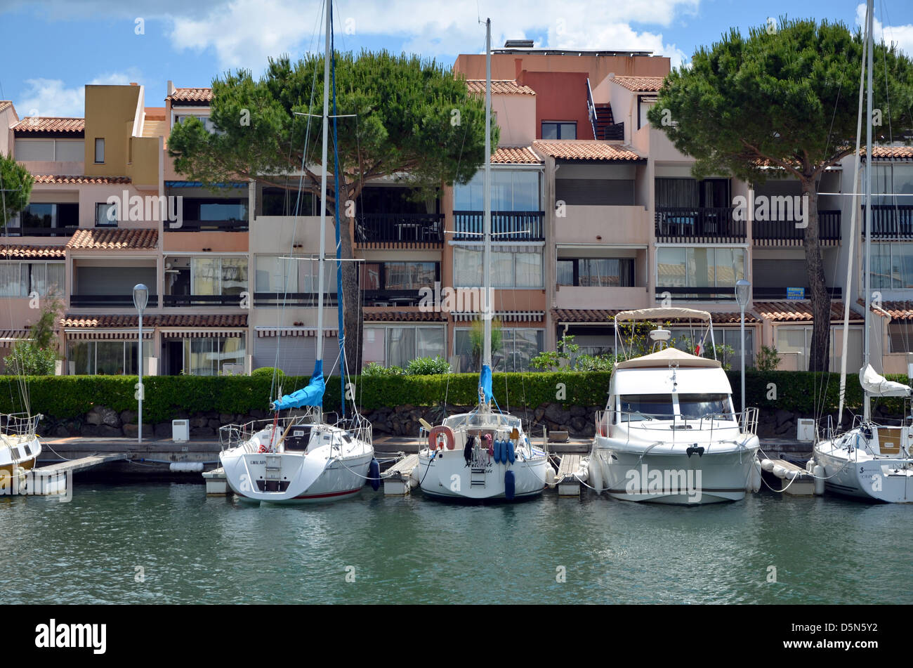Motor and sailing yachts are moored near appartements in Cap d'Adge at ...