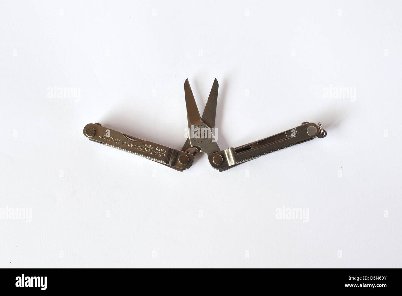 A micro leatherman multi tool photographed in a studio against a white ...
