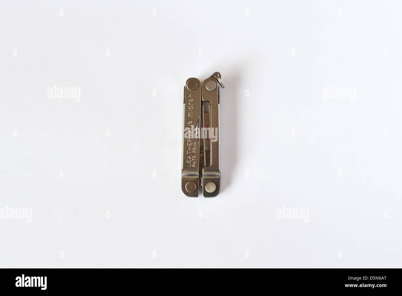 A micro leatherman multi tool photographed in a studio against a white ...