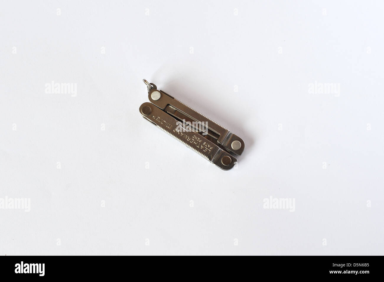 A micro leatherman multi tool photographed in a studio against a white ...