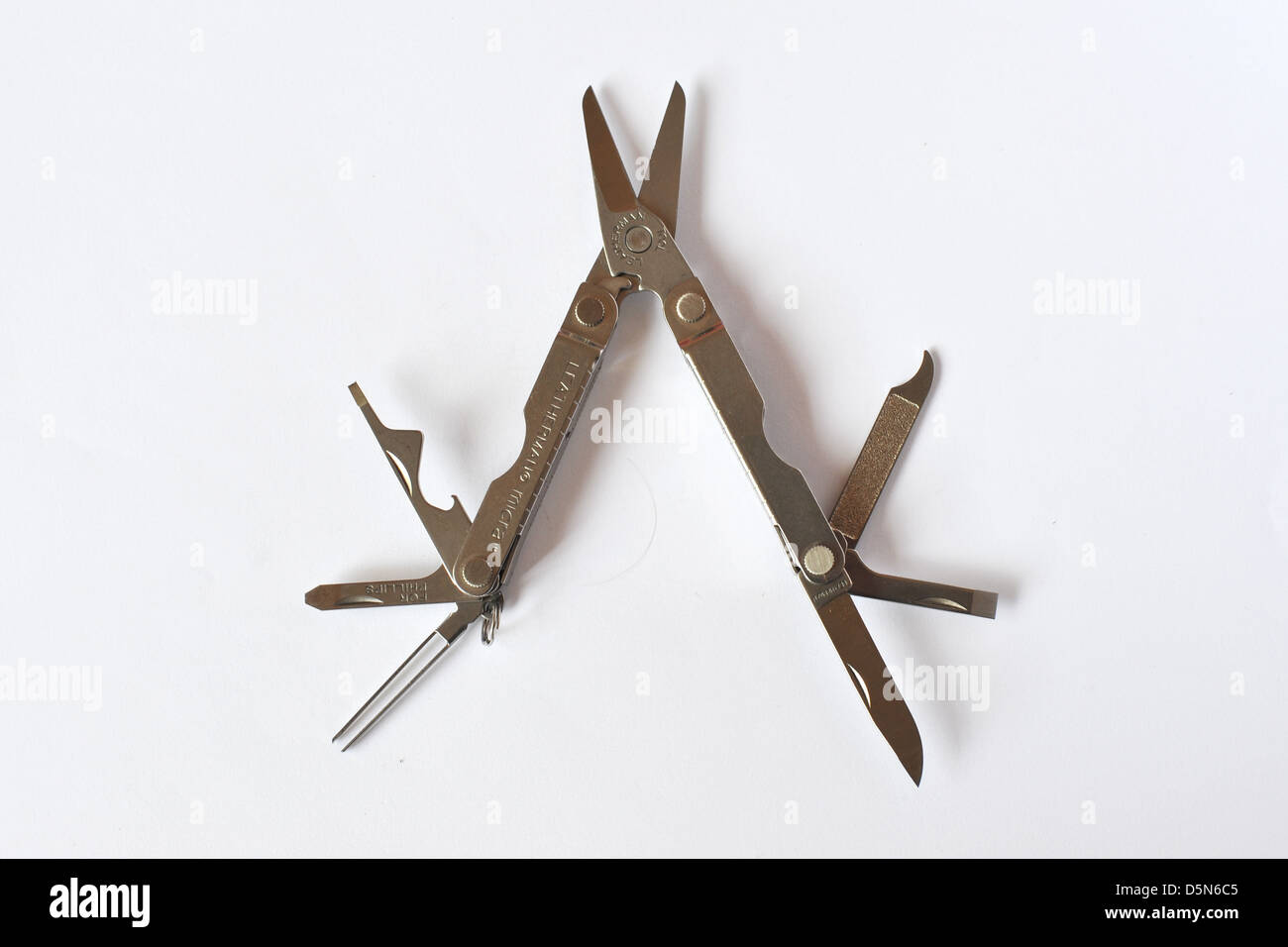 A micro leatherman multi tool photographed in a studio against a white ...