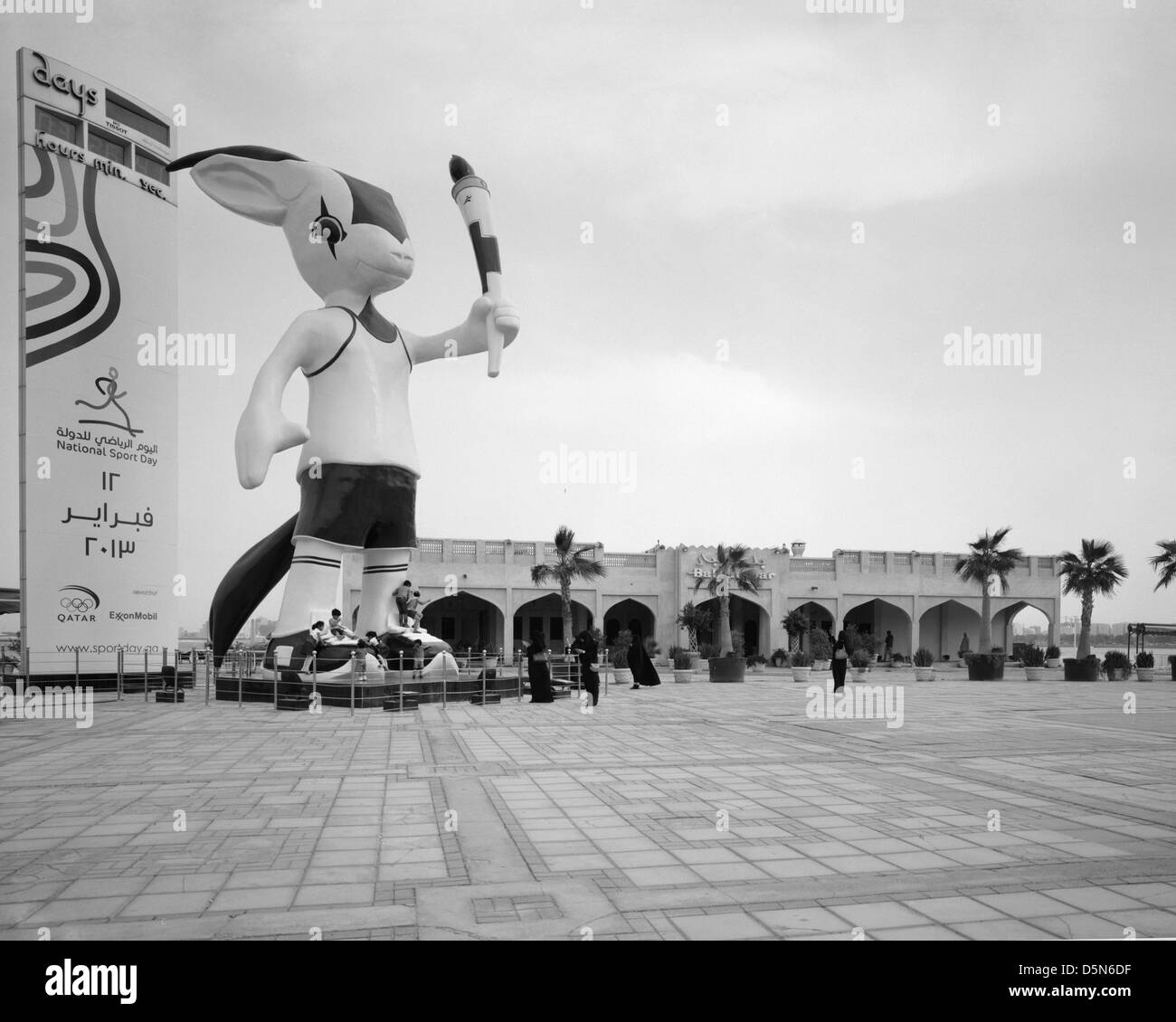 Qatari children play on the "Orry" statue, of Qatar's national mascot ...