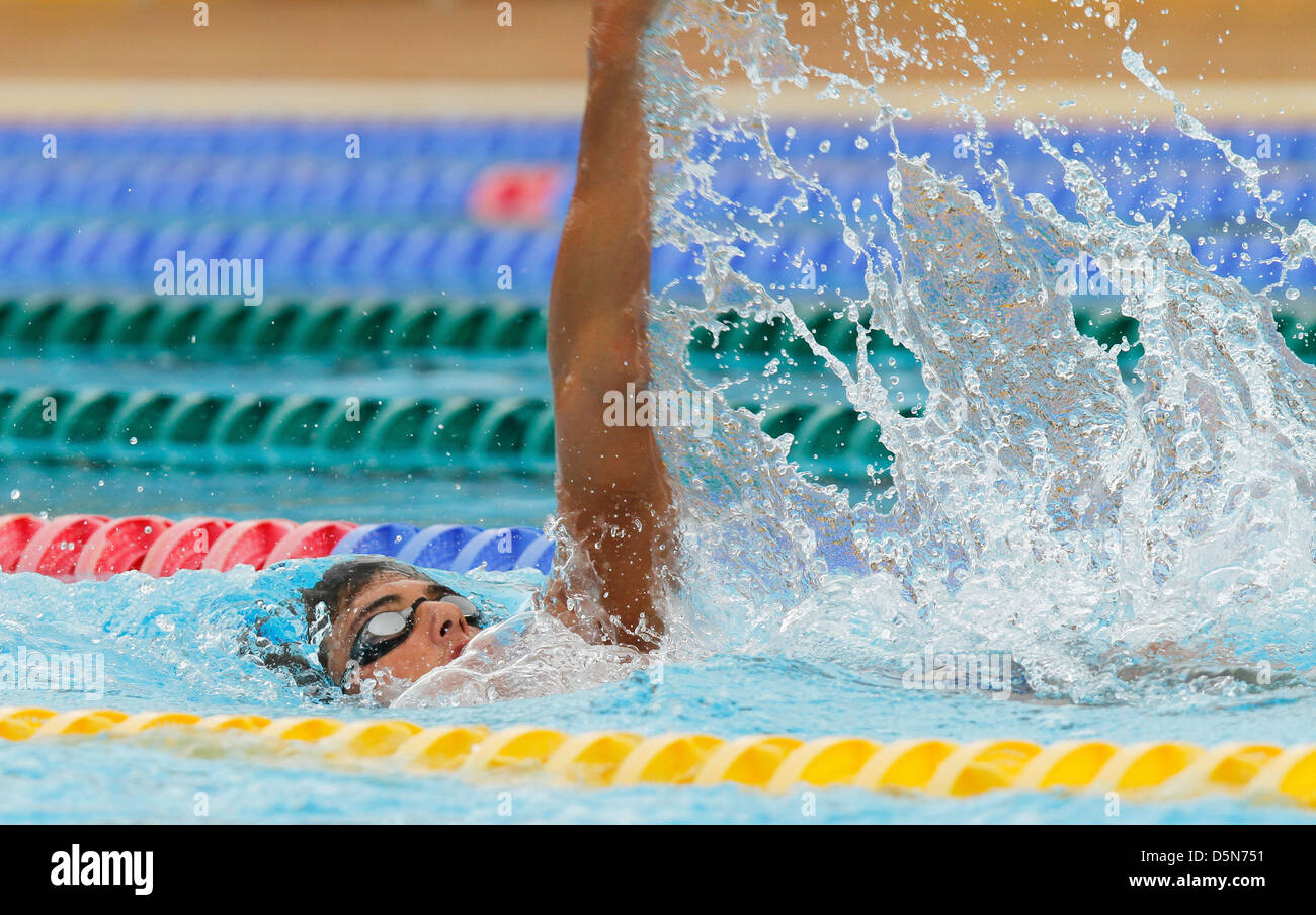 A boy swims backstroke on a swimming pool during her training session ...