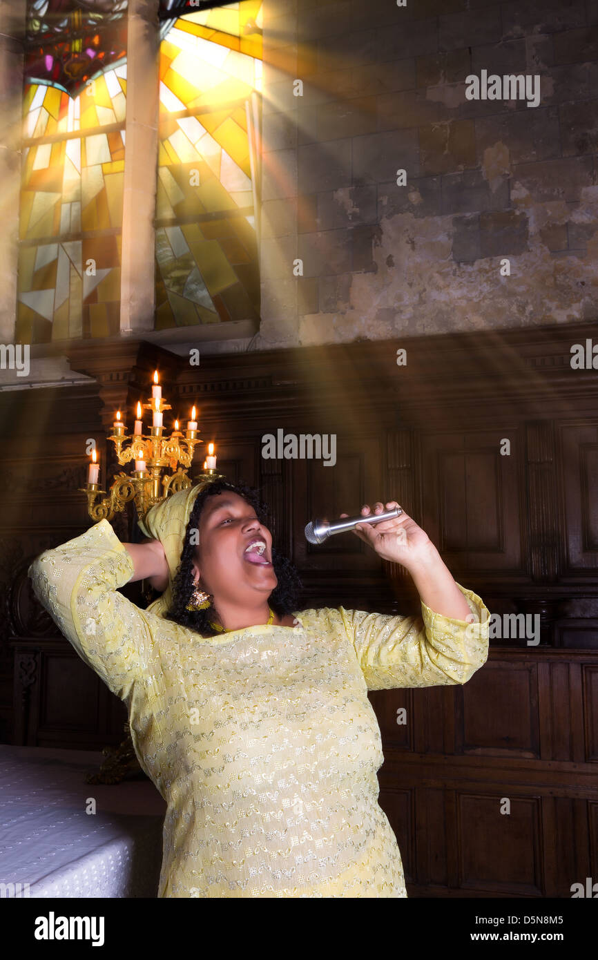 Gospel singer during mass with sunshine through the stained glass ...