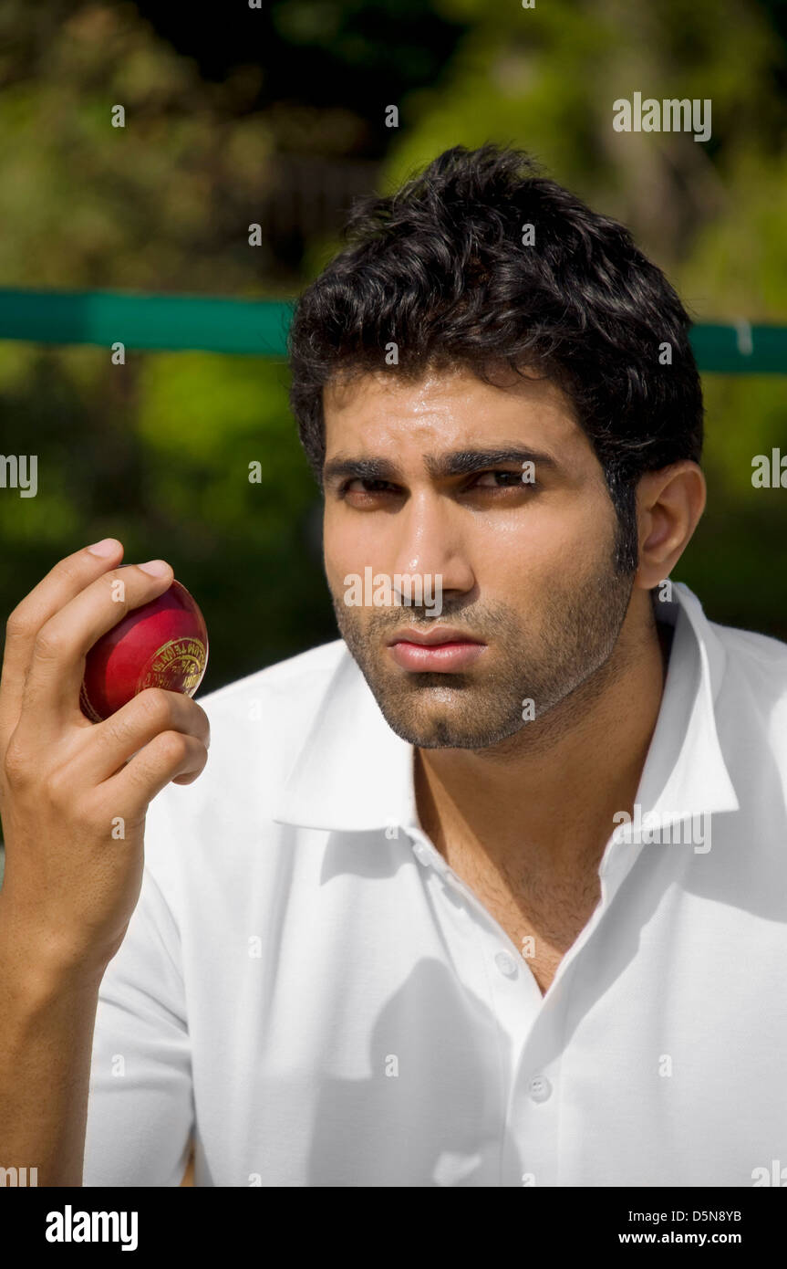 Portrait of a bowler with cricket ball Stock Photo - Alamy