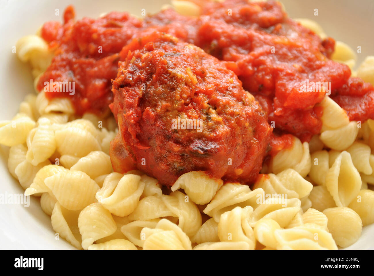 Shell Pasta with Sauce and a Meatball in a Bowl Stock Photo - Alamy
