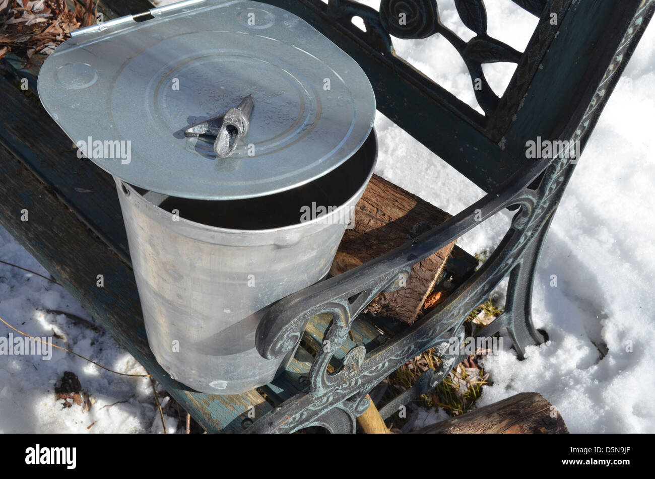 The tools for collecting maple sap - a spigot, cover and bucket, rest ...