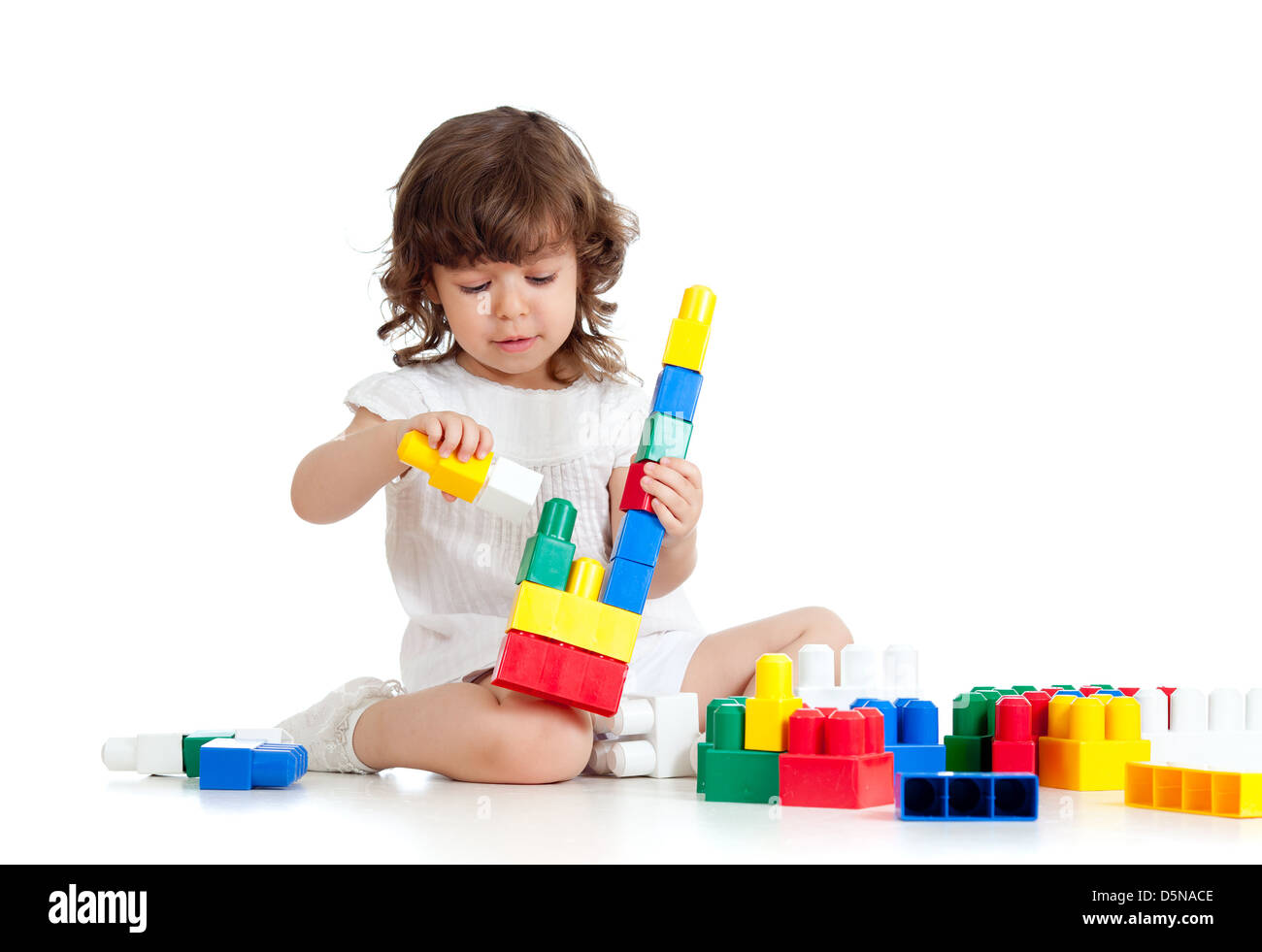 little cheerful child with construction set over white background Stock ...