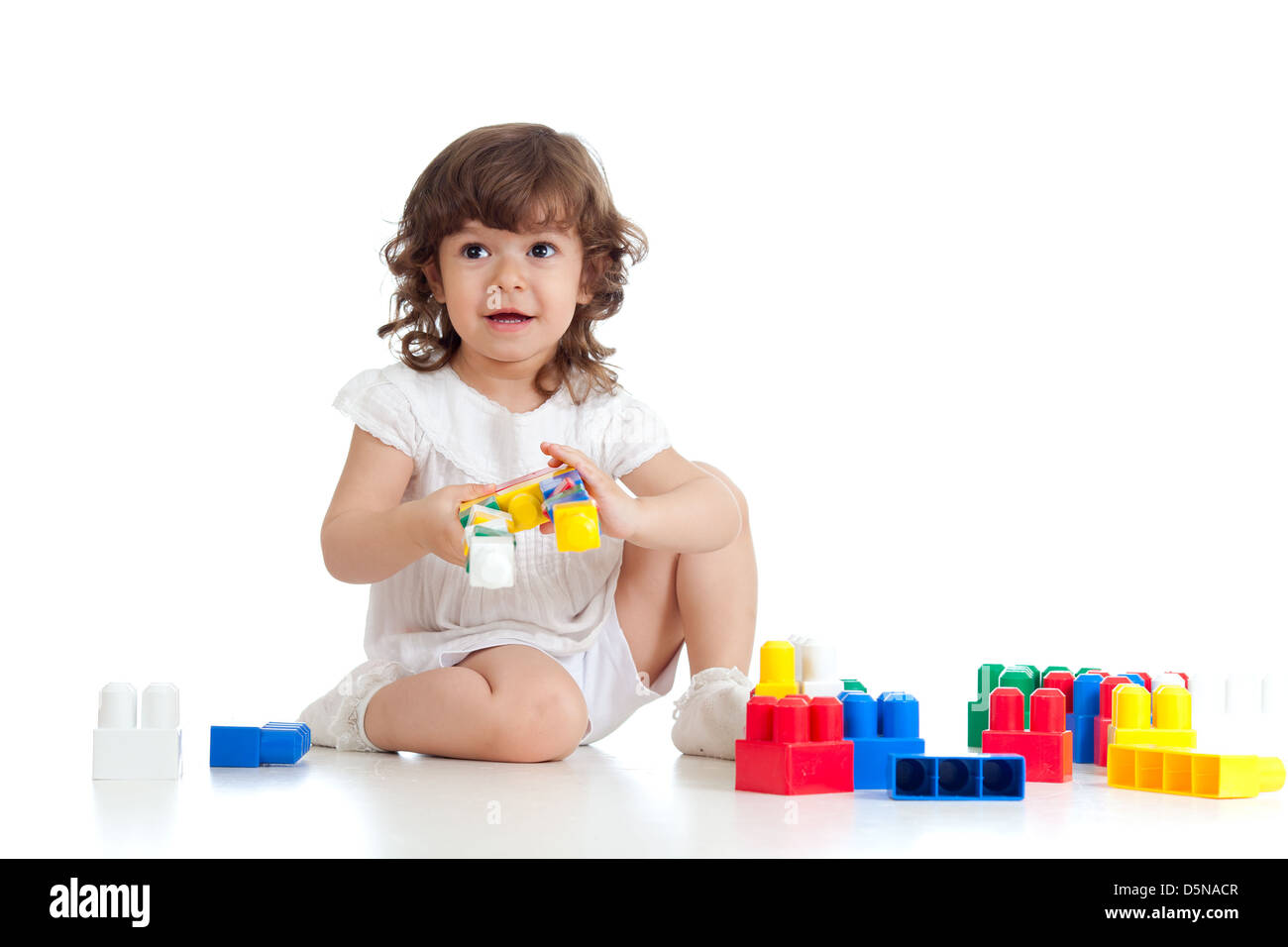little cheerful child with construction set over white background Stock ...