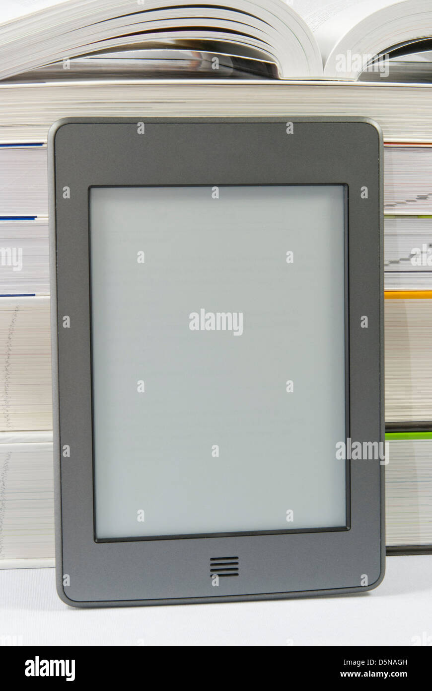 Electronic book reader with blank screen and pile of books Stock Photo ...