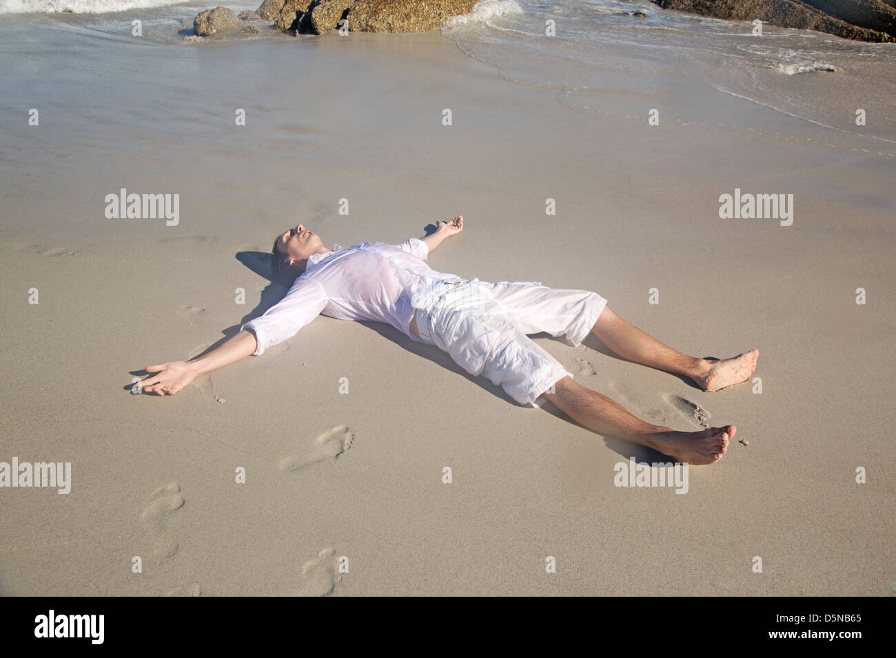 Man Lying on Beach Stock Photo - Alamy