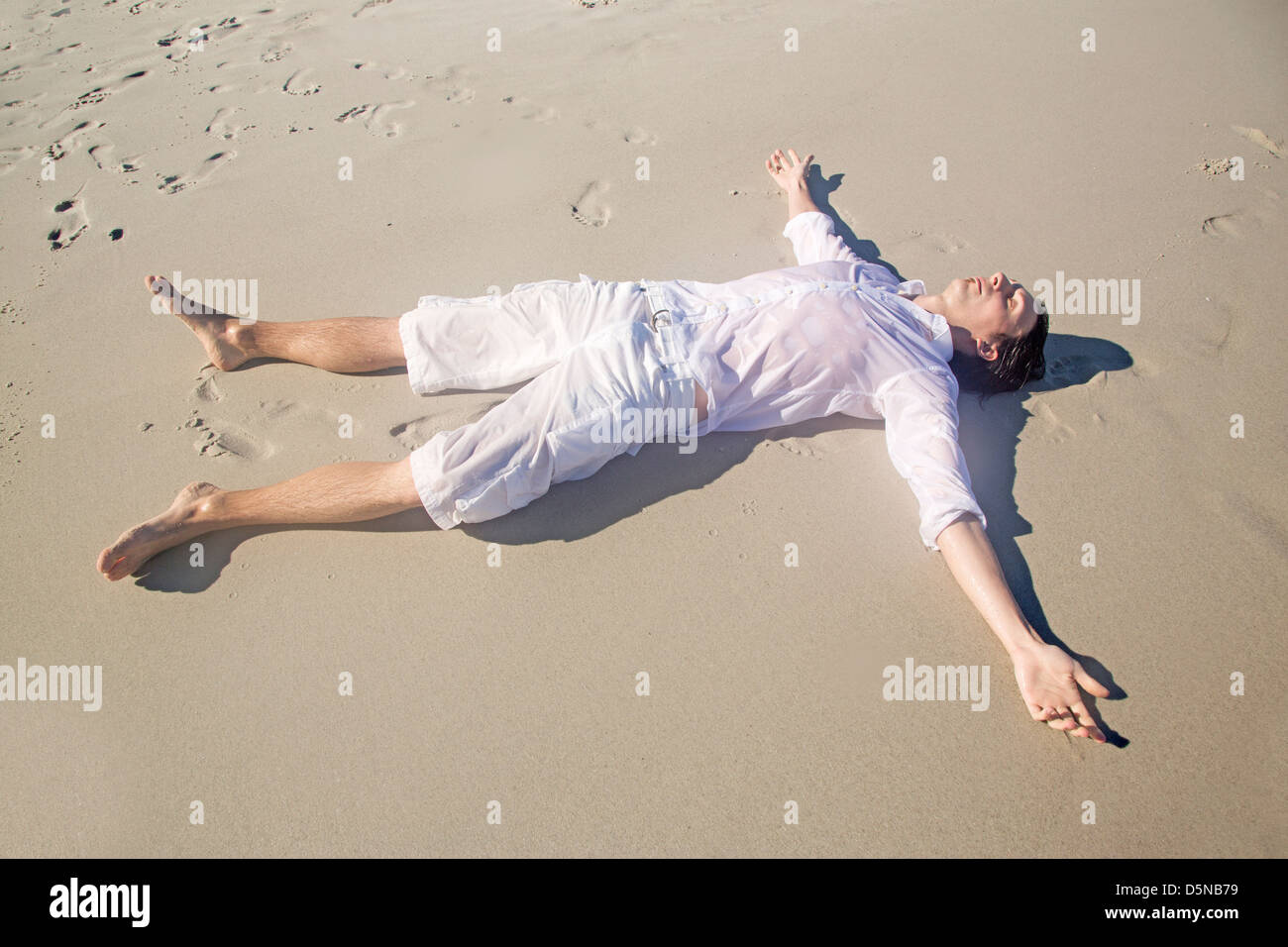 Man Lying on Beach Stock Photo - Alamy
