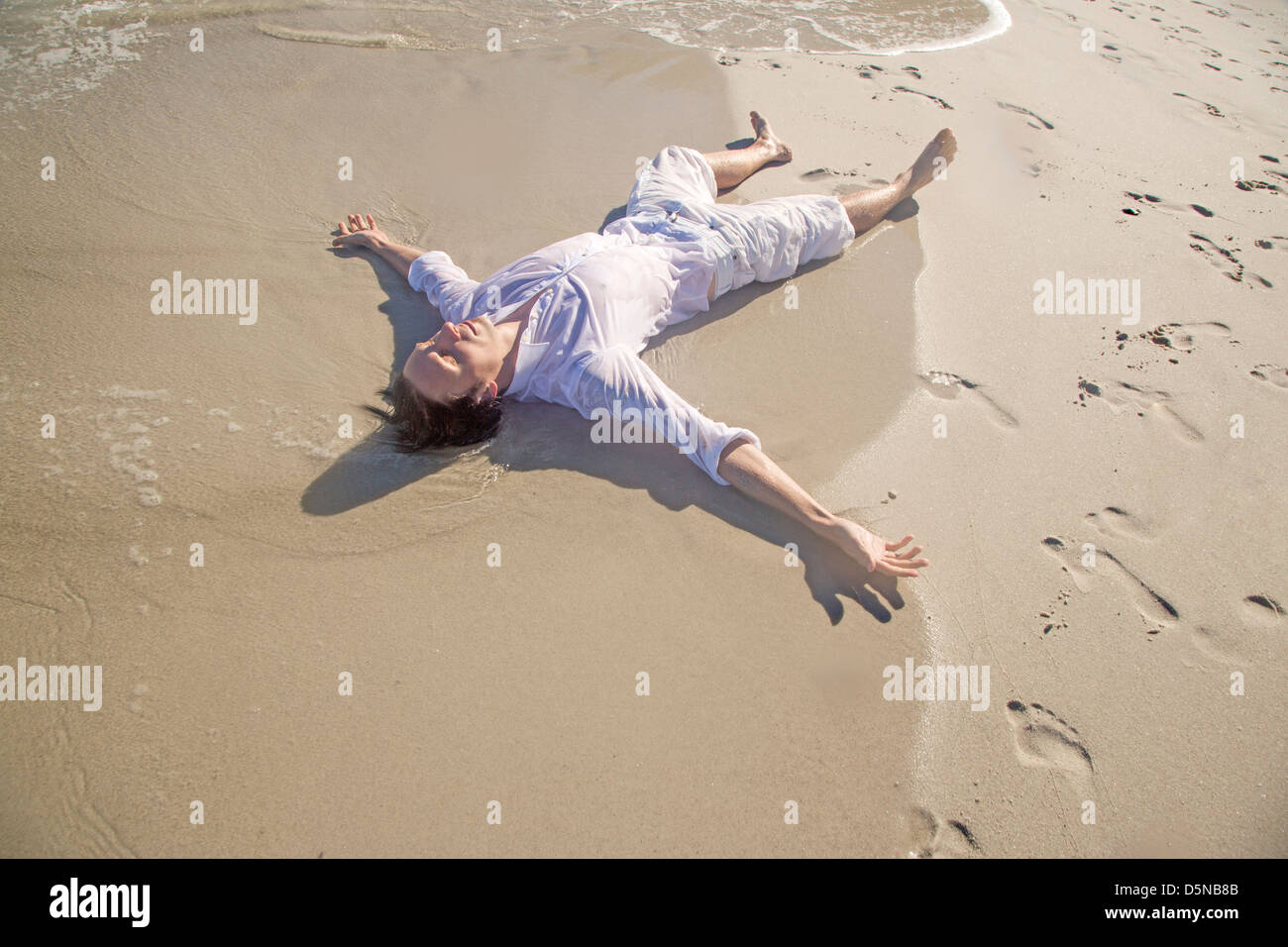 Man Lying on Beach Stock Photo - Alamy
