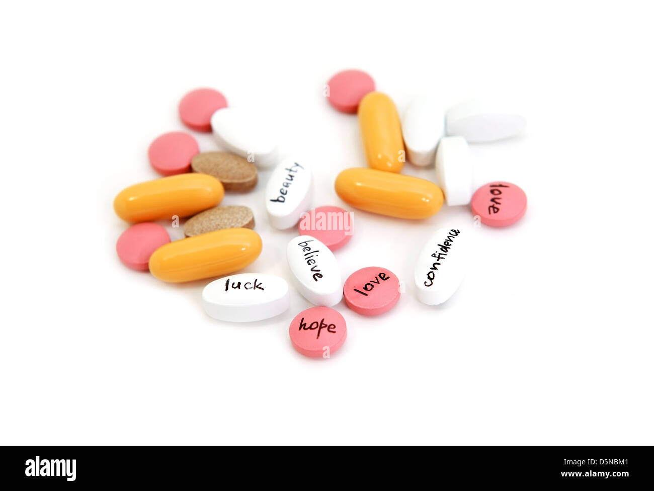 different pills with signs hope, beauty, love, confidence on white ...