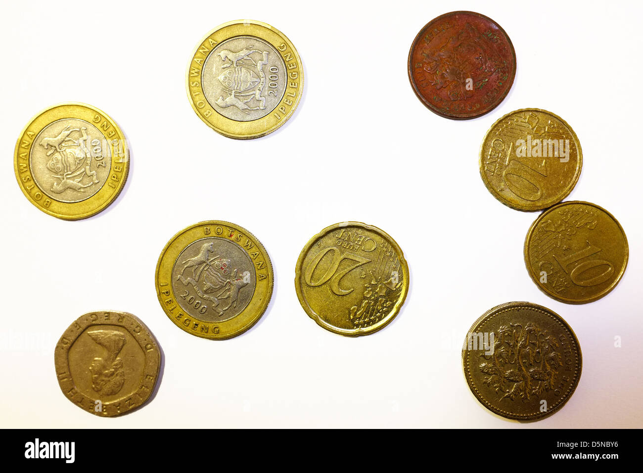 A selection of Euros and Pound coins photographed in a studio against a ...