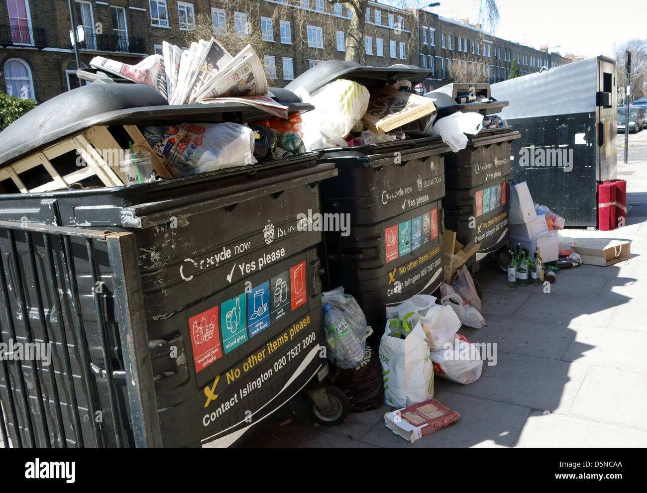 Overflowing recycling containers in London street Stock Photo - Alamy