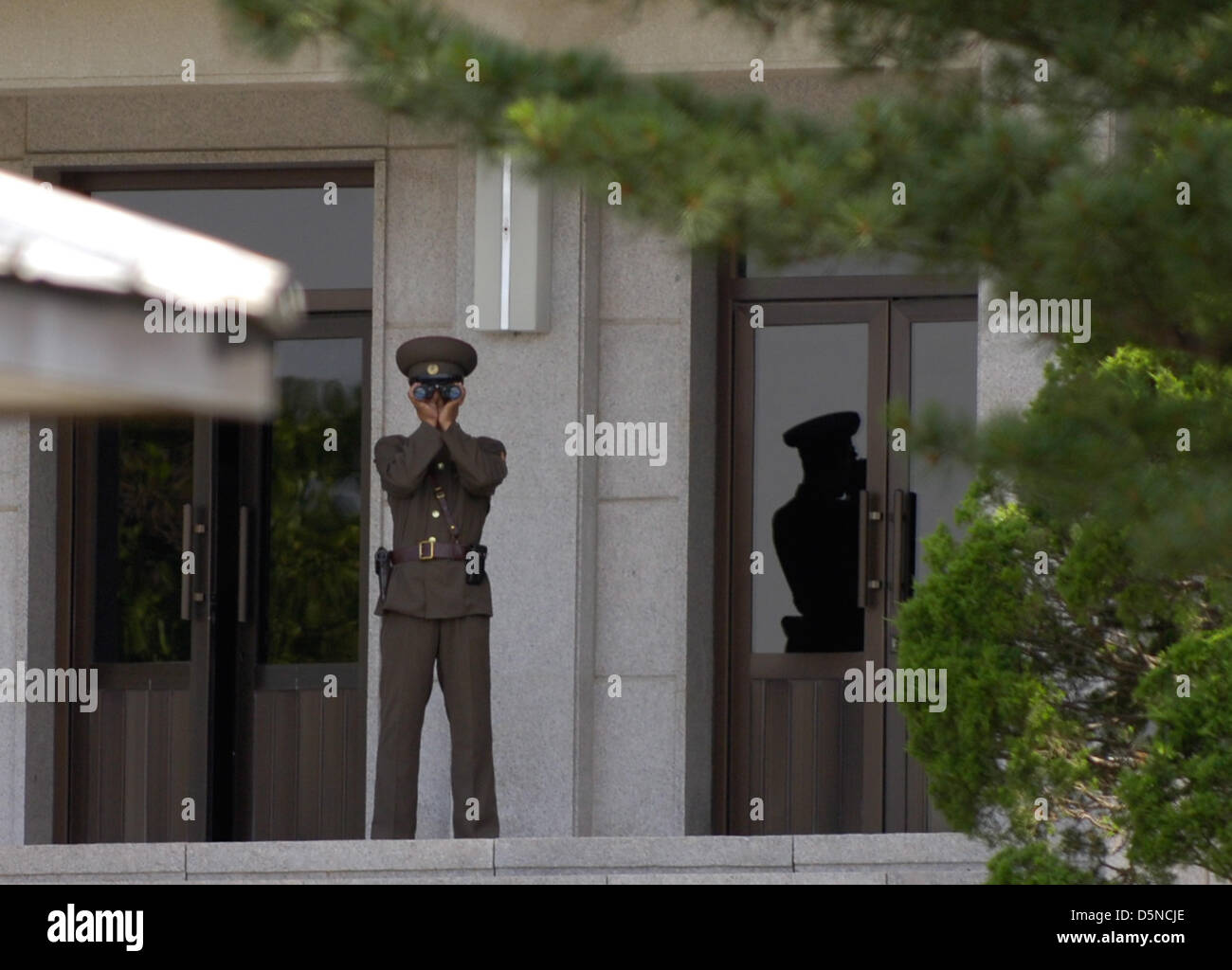 A North Korean guard stands on the border of the Demilitarized Zone ...