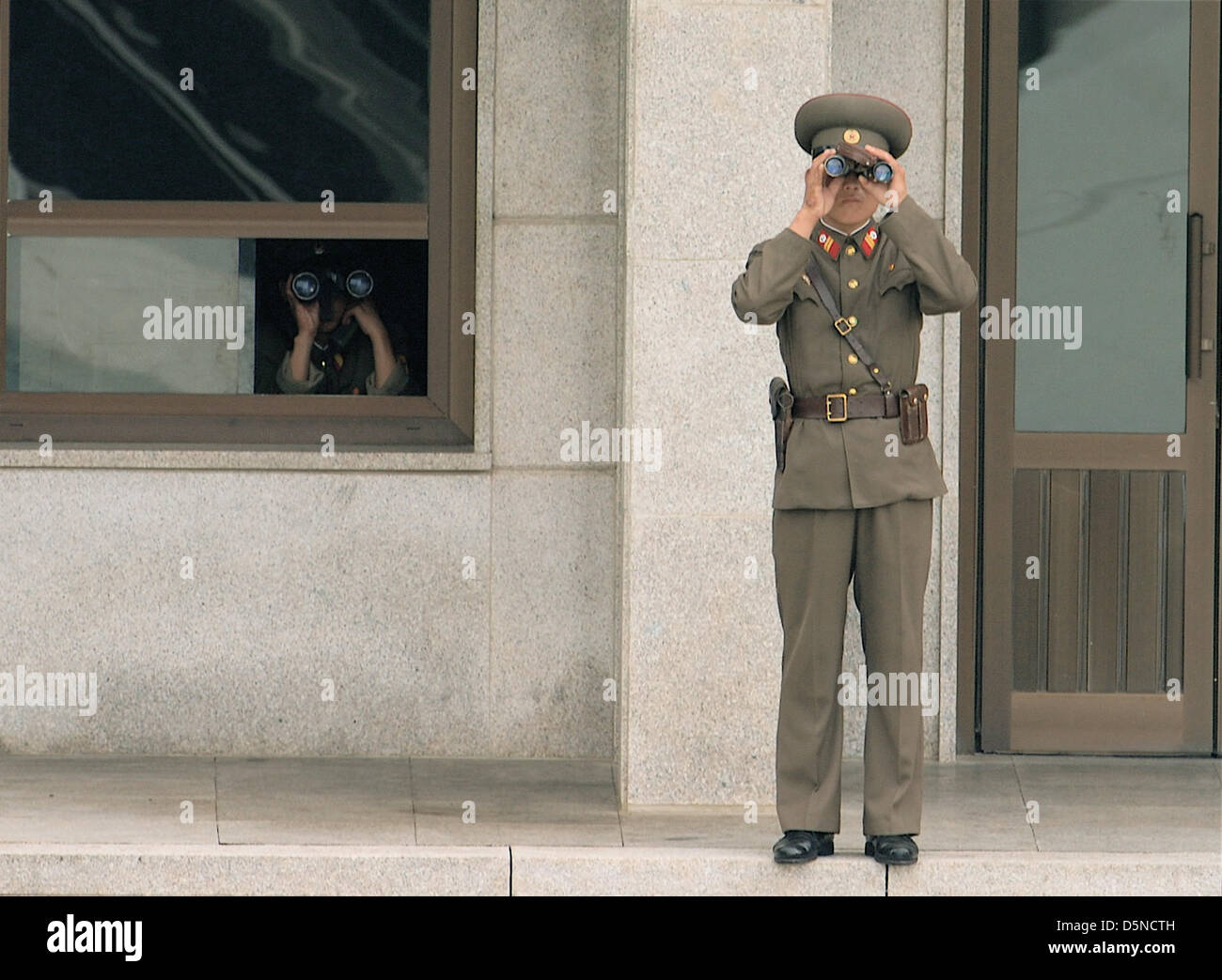 A North Korean guard stands on the border of the Korean Demilitarized ...
