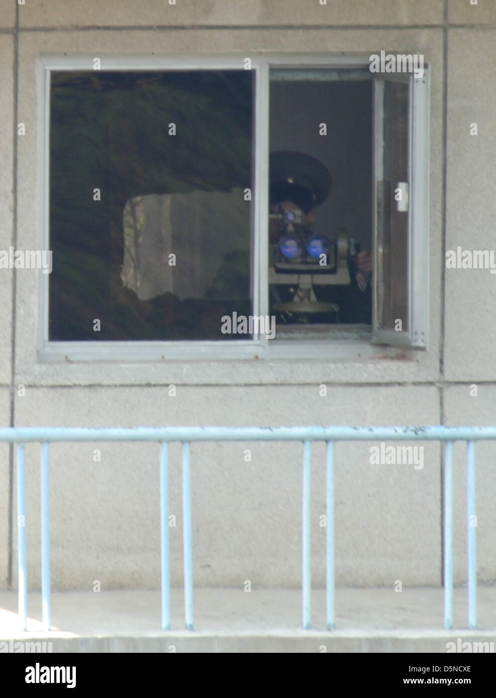 A North Korean guard stands at the demilitarized zone (DMZ), observing ...