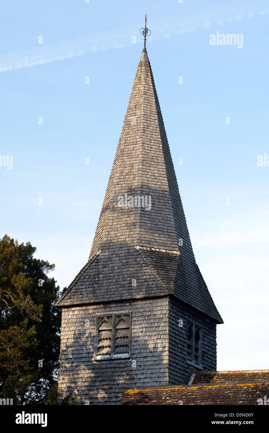 The spire of Itchingfield Church showing the wooden tiles or shungles ...