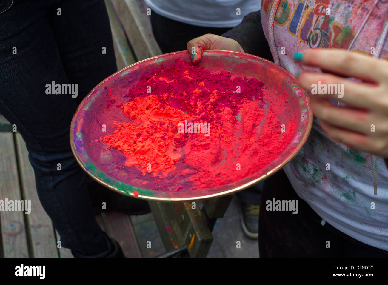 Colored powder is applied to the faces of participants as they ...