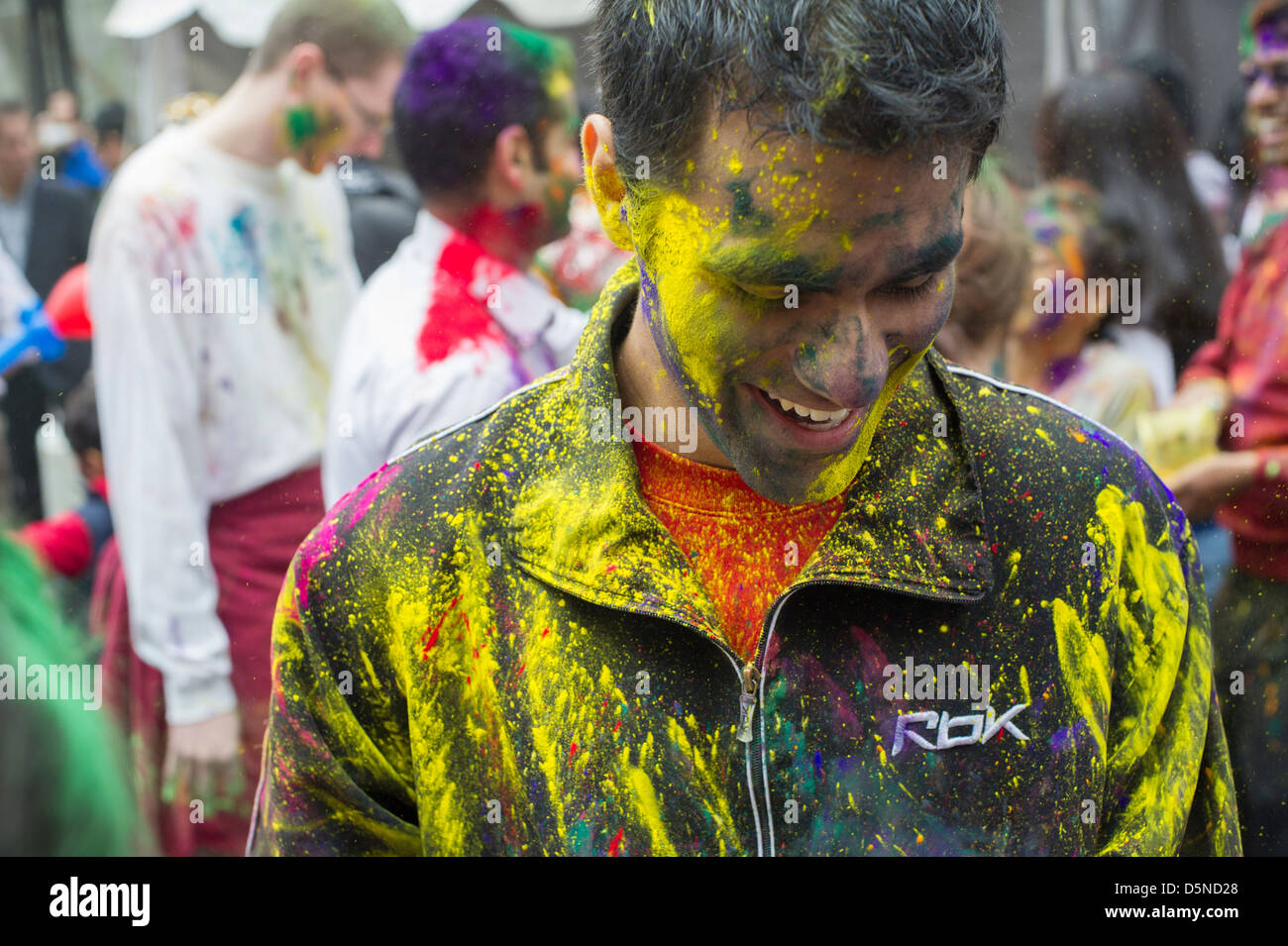 Colored powder is applied to the faces of participants as they ...