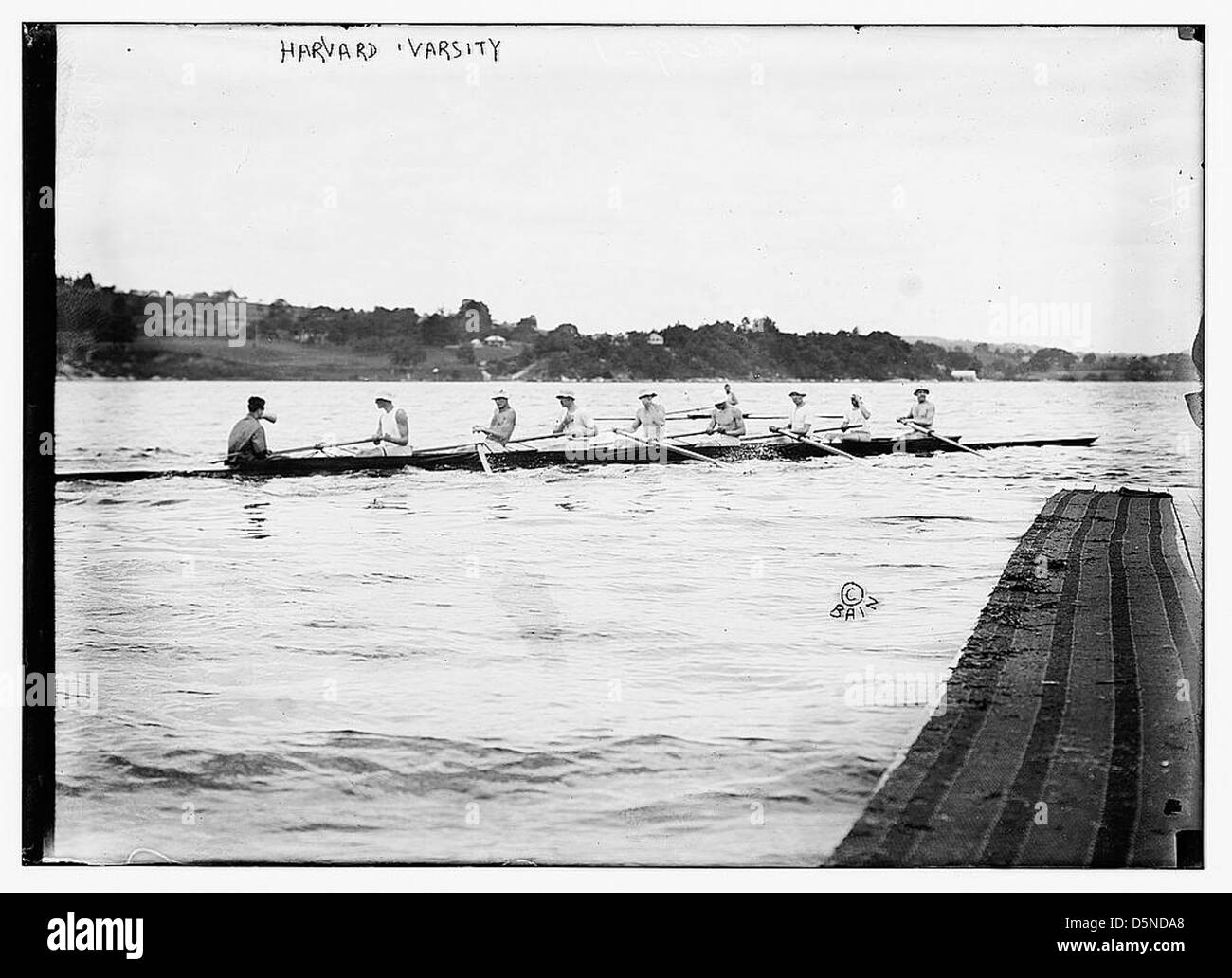 The Harvard University crew team is shown rowing in 1911, highlighting ...