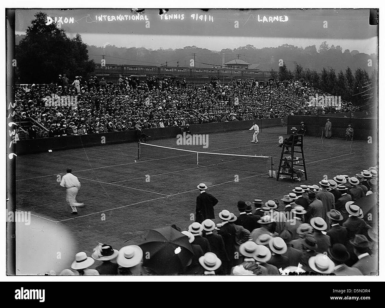 This photograph captures an international tennis match in the 1910s ...
