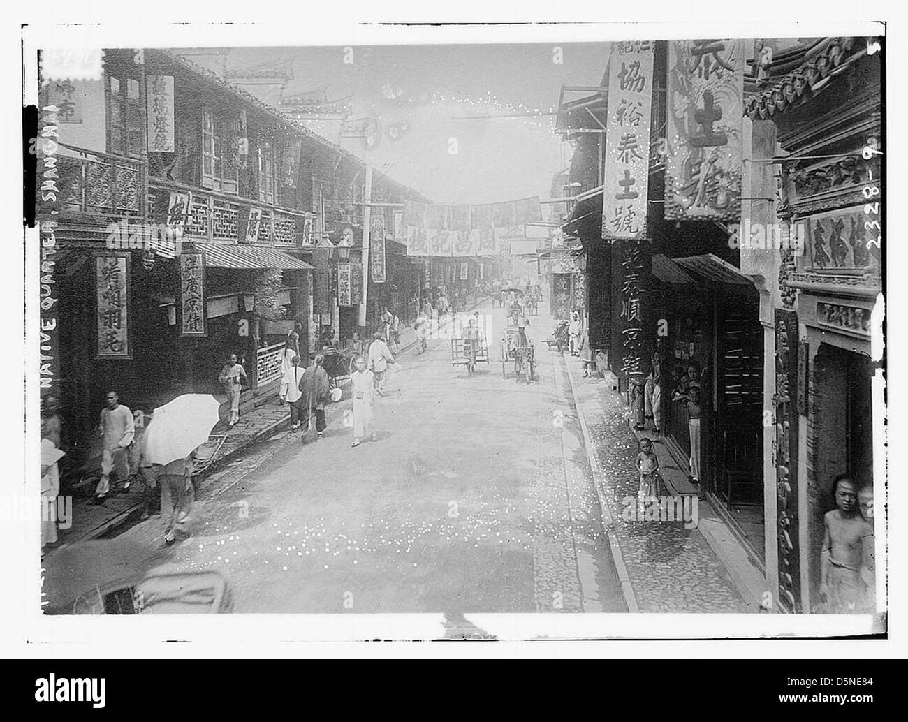 This photograph shows a bustling street scene in the Native Quarter of ...