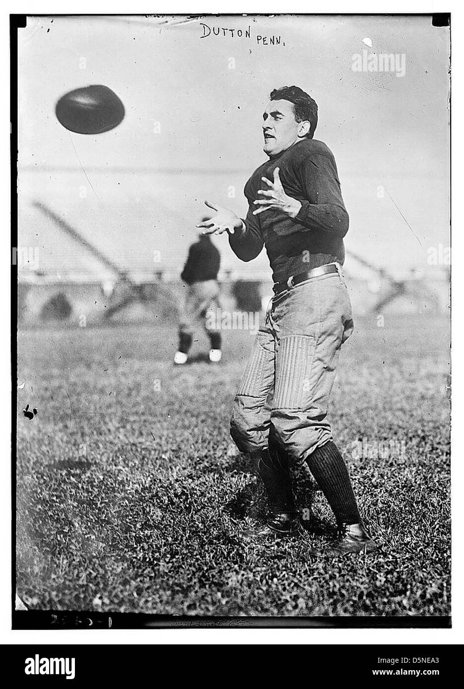 This action shot from the 1910s shows a football player in mid-play ...
