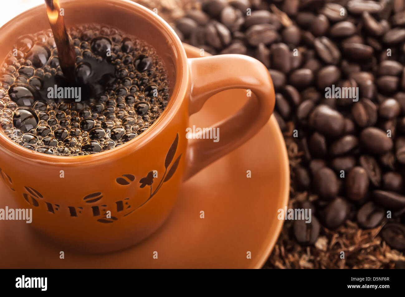 Coffee cup with fresh coffee beans Stock Photo - Alamy