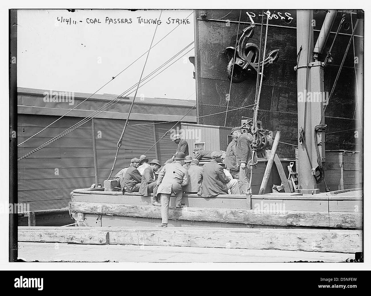 The photograph shows coal passers discussing a strike on June 14, 1911 ...