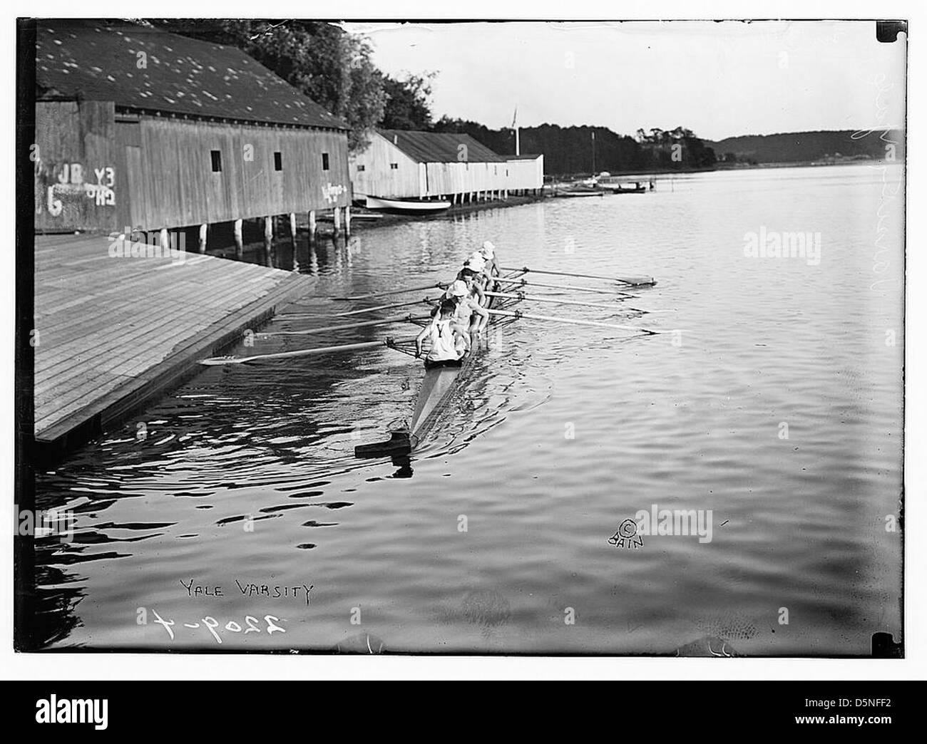 A Yale Varsity rowing team competes against Harvard crew in the 1910s ...