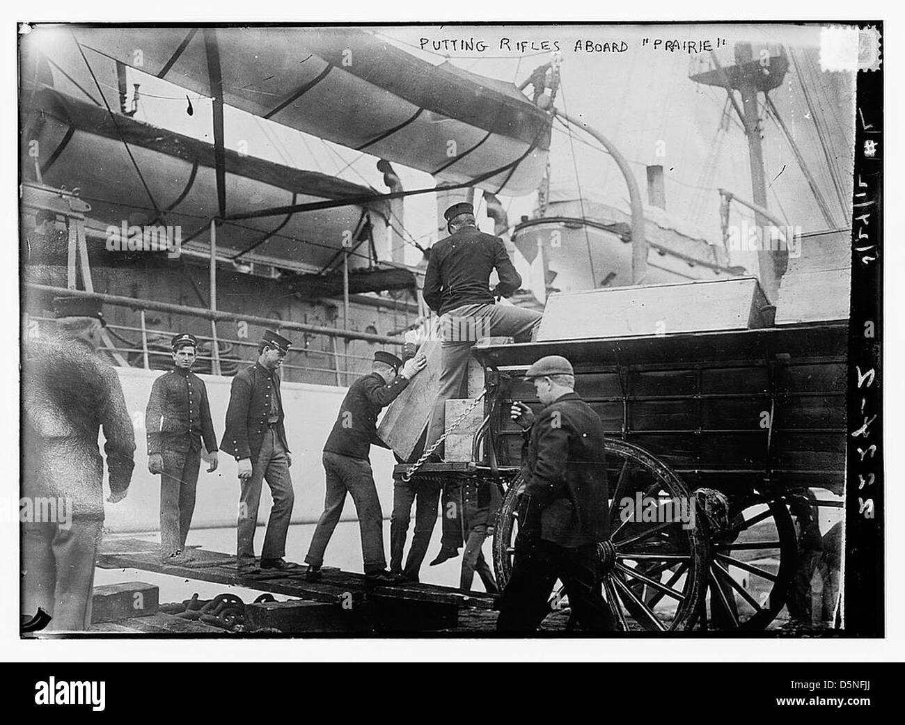This photograph captures military personnel loading rifles aboard the ...