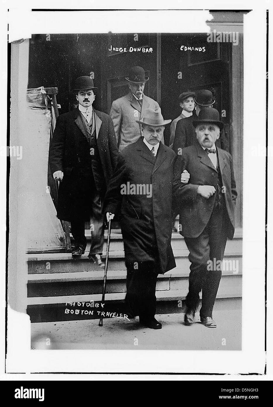 Judge Dunbar and Edmands, both dressed in 3-piece suits, are shown in ...