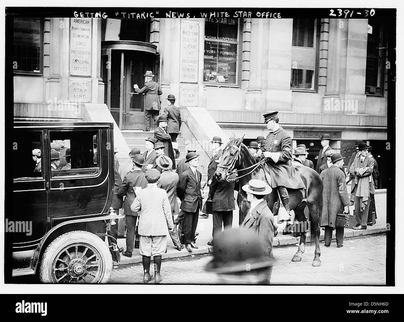 A photograph showing a scene at the White Star Line office in the 1910s ...