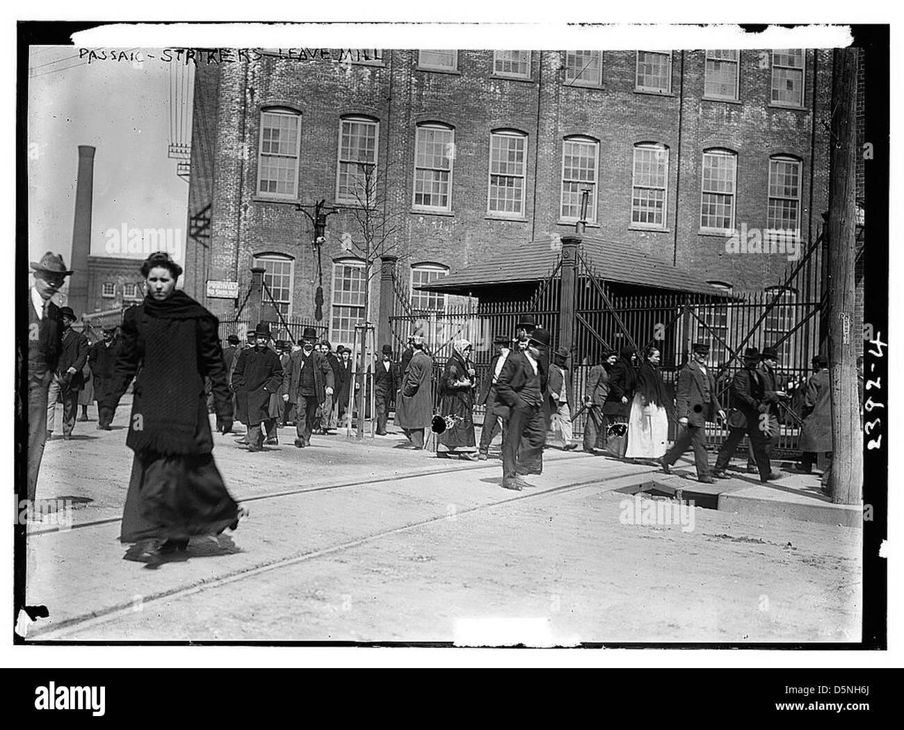 This photograph shows workers leaving a mill during a strike in Passaic ...
