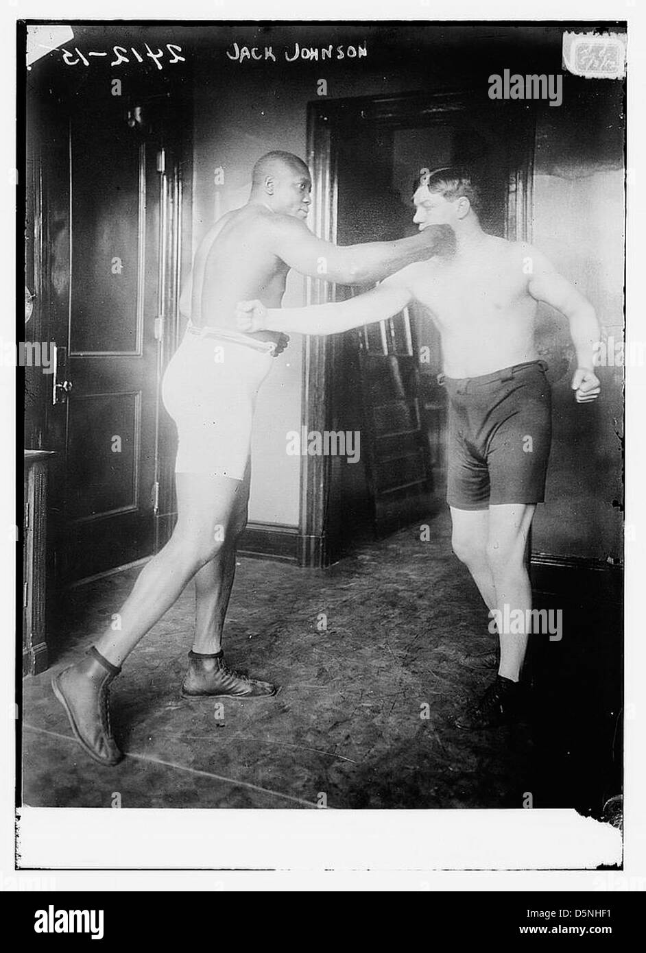 This iconic black-and-white photograph shows Jack Johnson, a legendary ...