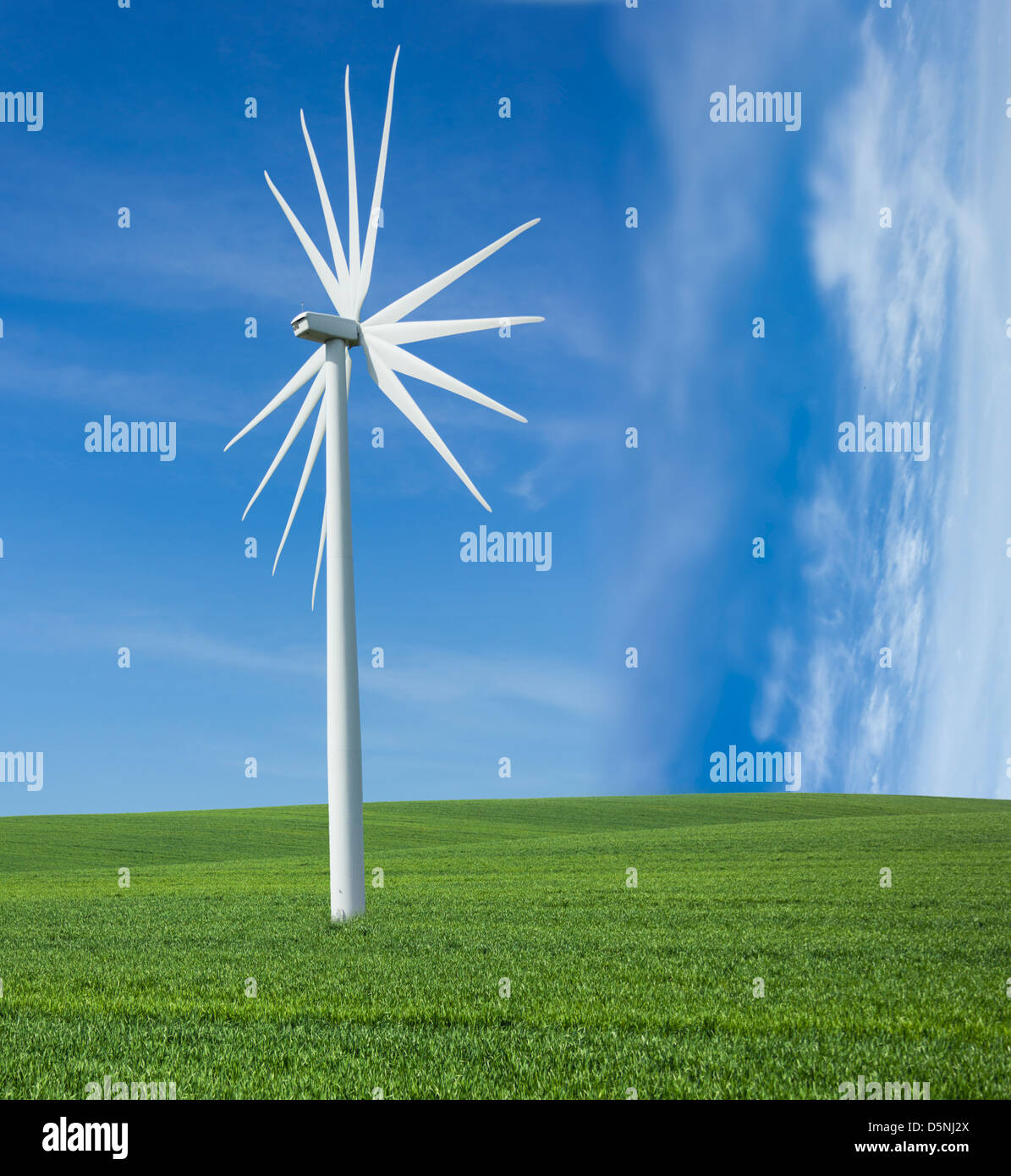Windmill power generator on green grass and blue sky Stock Photo - Alamy