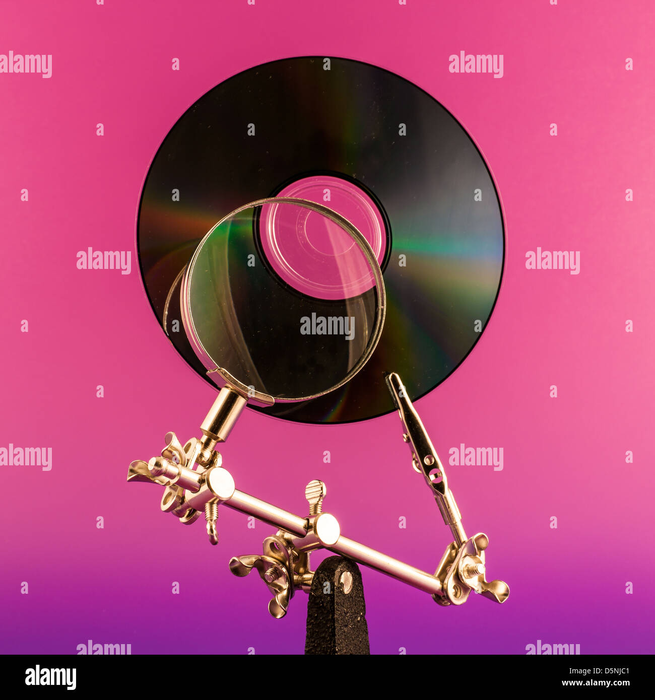 concept-for-data-analysis-cd-and-lens-on-a-vivid-colors-background