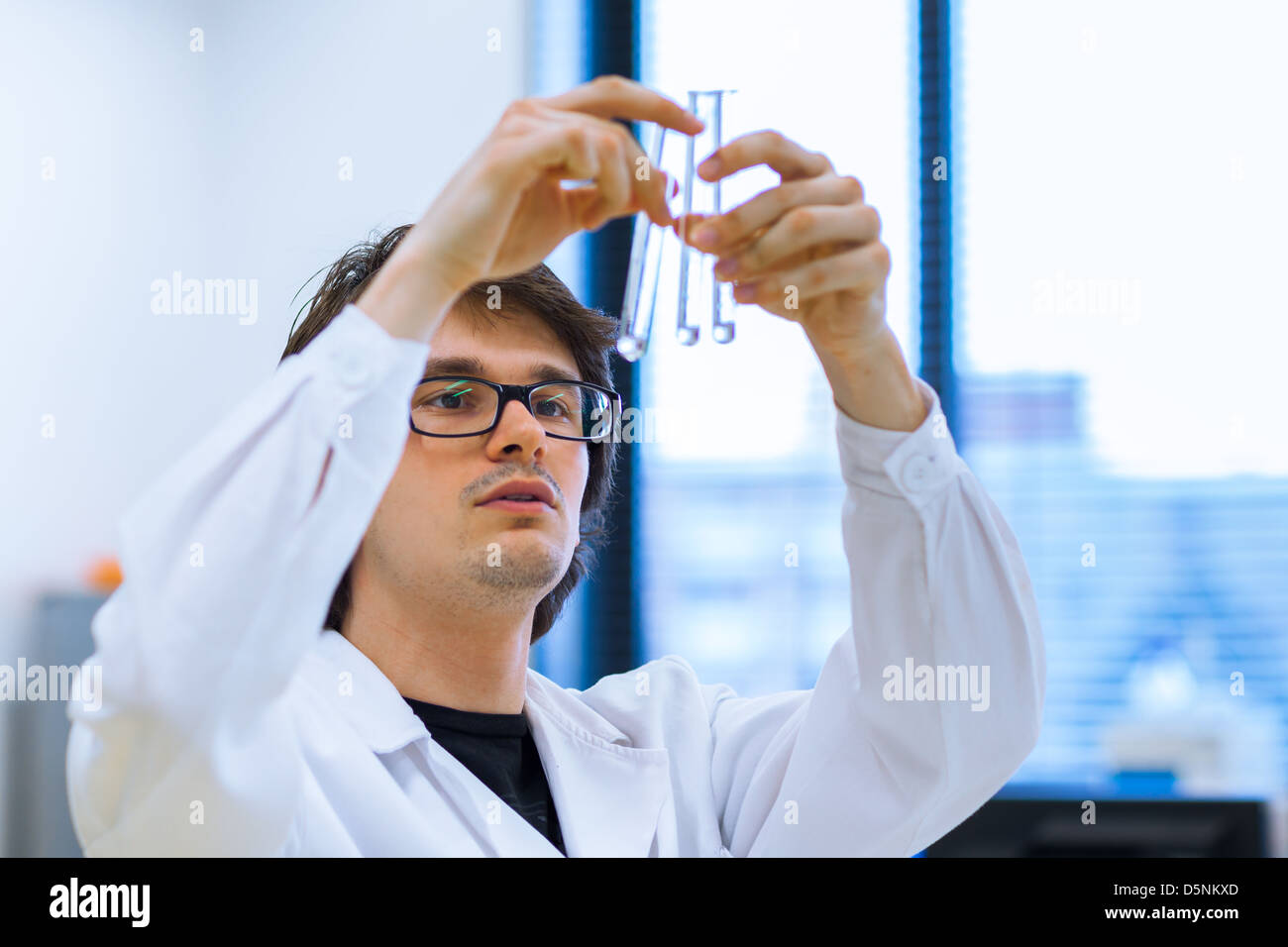 Young male researcher carrying out scientific research in a lab ...
