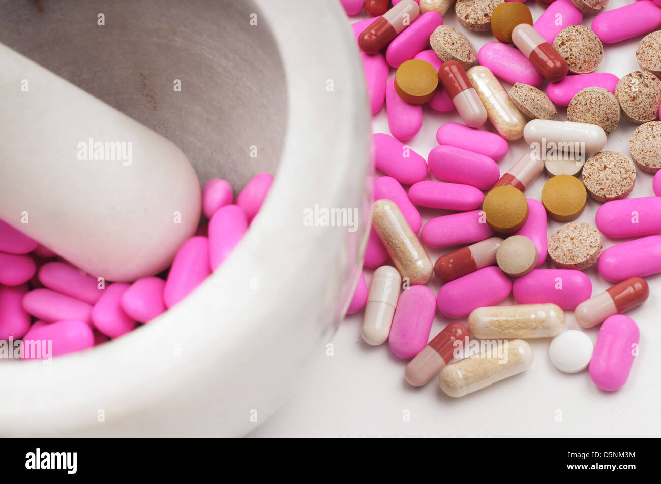 Shot of pink drugs and mortar grinding machine Stock Photo - Alamy
